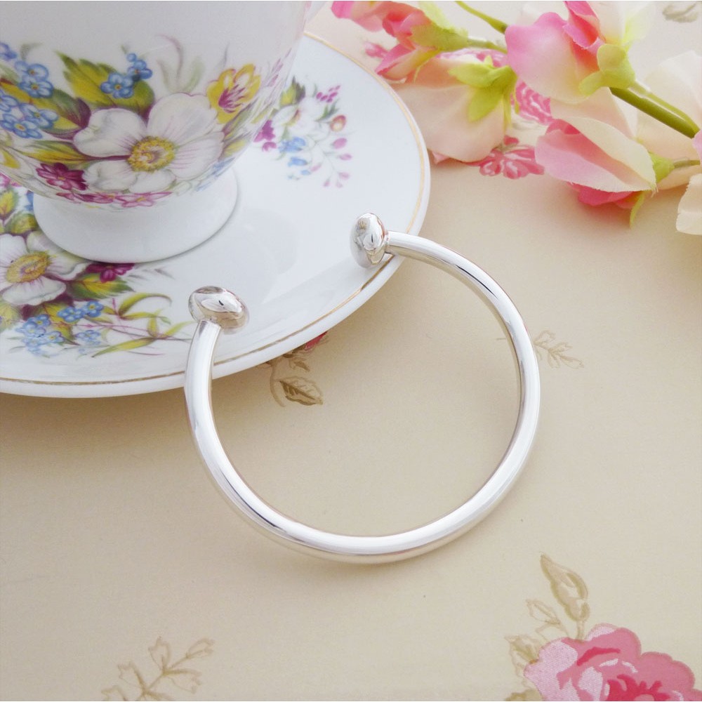 Ladies Solid Silver Torque Bangle With Minstrel Shaped Ball Ends