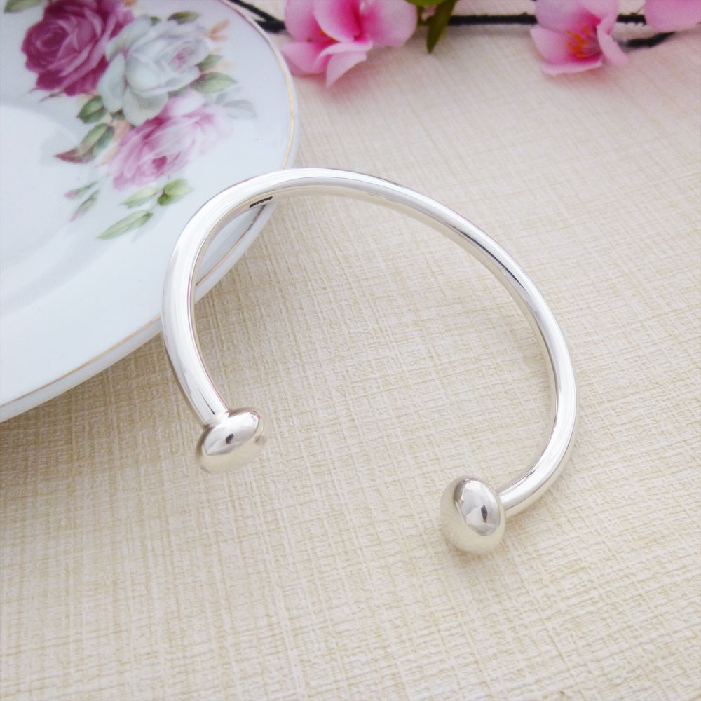 Ladies Solid Silver Torque Bangle With Minstrel Shaped Ball Ends