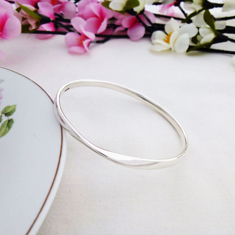 Sterling Silver Plain Solid Bangle featuring a Funky Twist Design.
