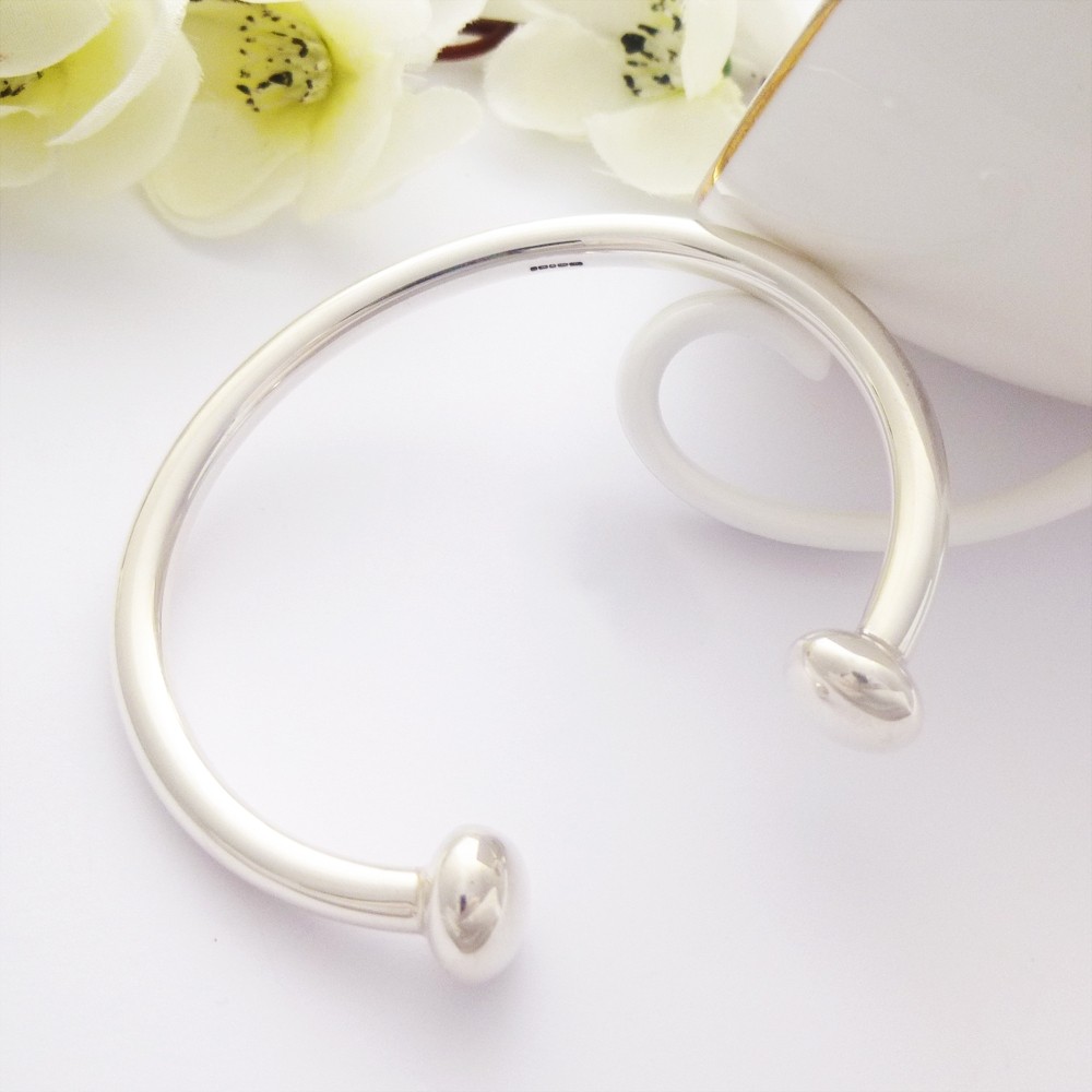 Ladies Solid Silver Torque Bangle With Minstrel Shaped Ball Ends